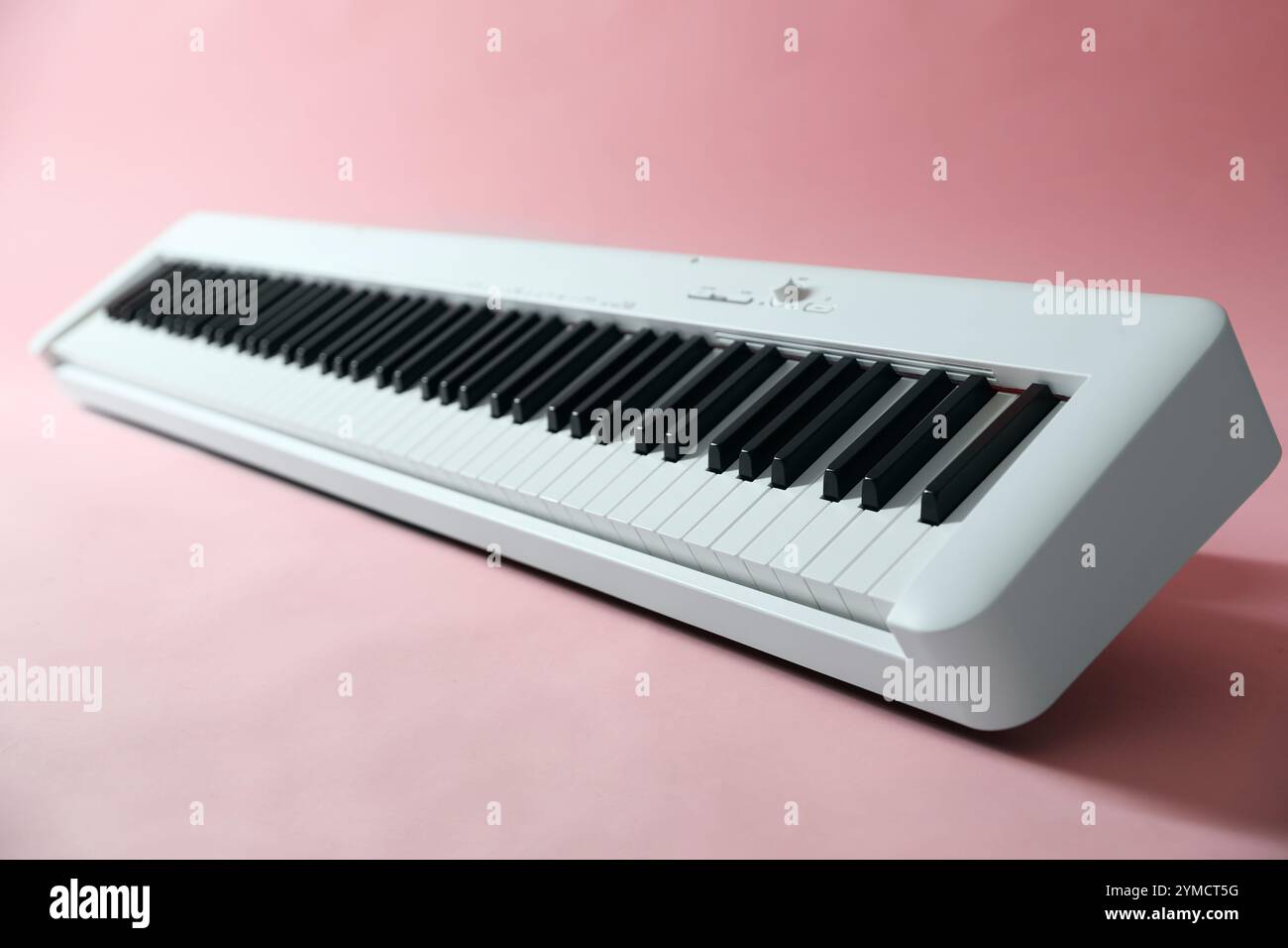 Synthesizer on pink background, closeup. Electronic musical instrument ...