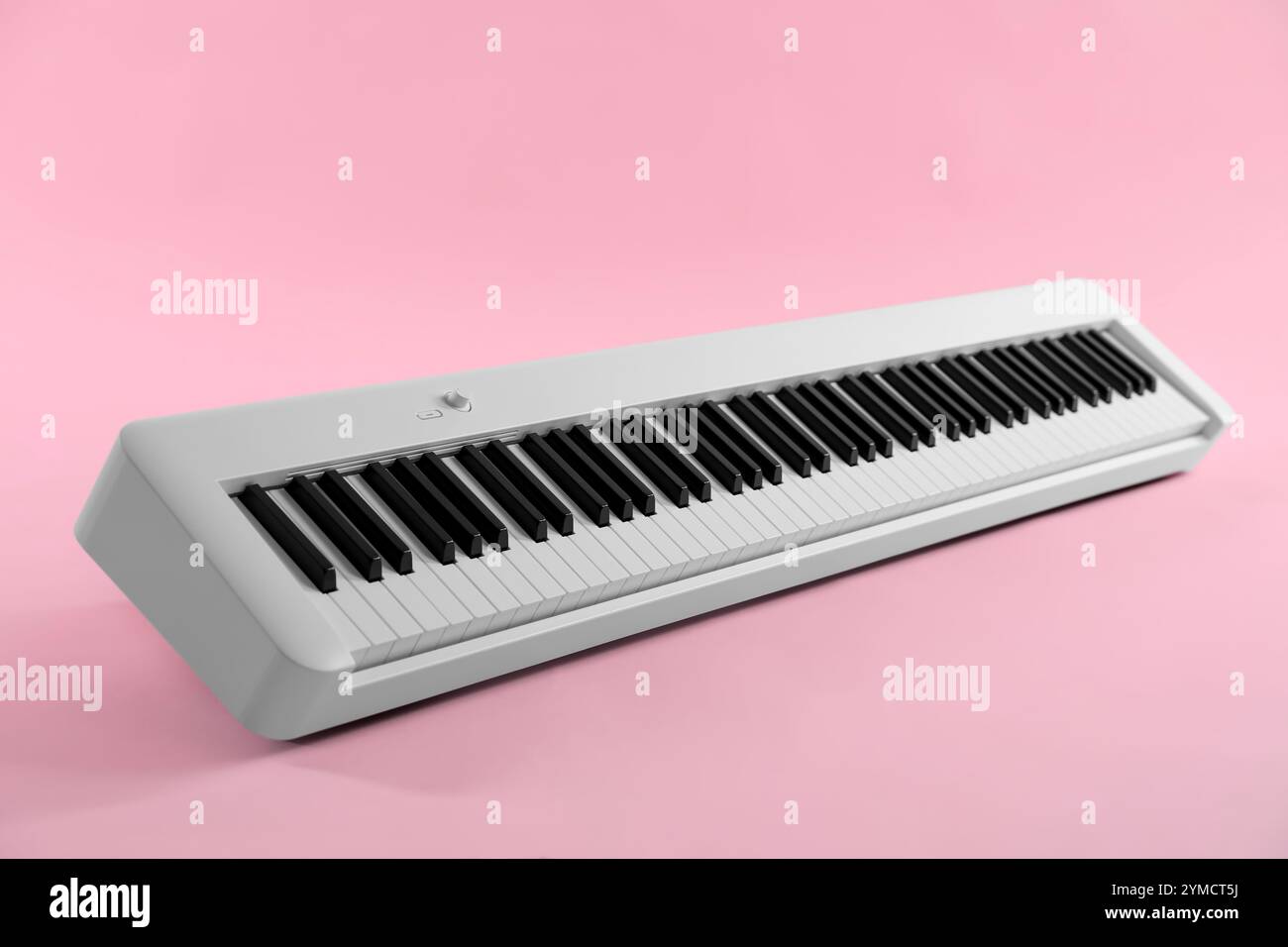 Synthesizer on pink background, closeup. Electronic musical instrument ...
