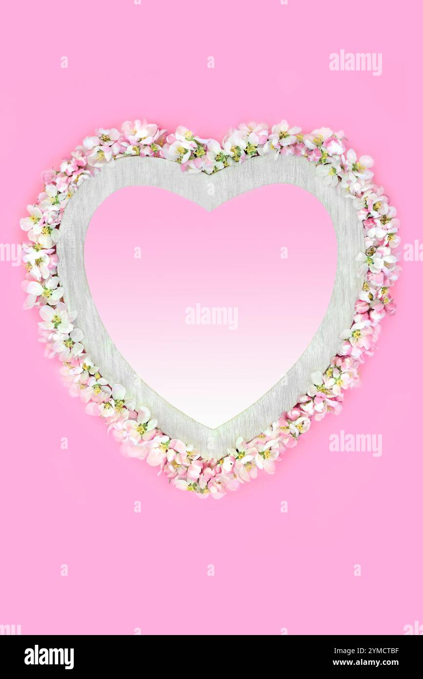 Heart shape Spring Beltane wooden wreath on pink background with apple ...