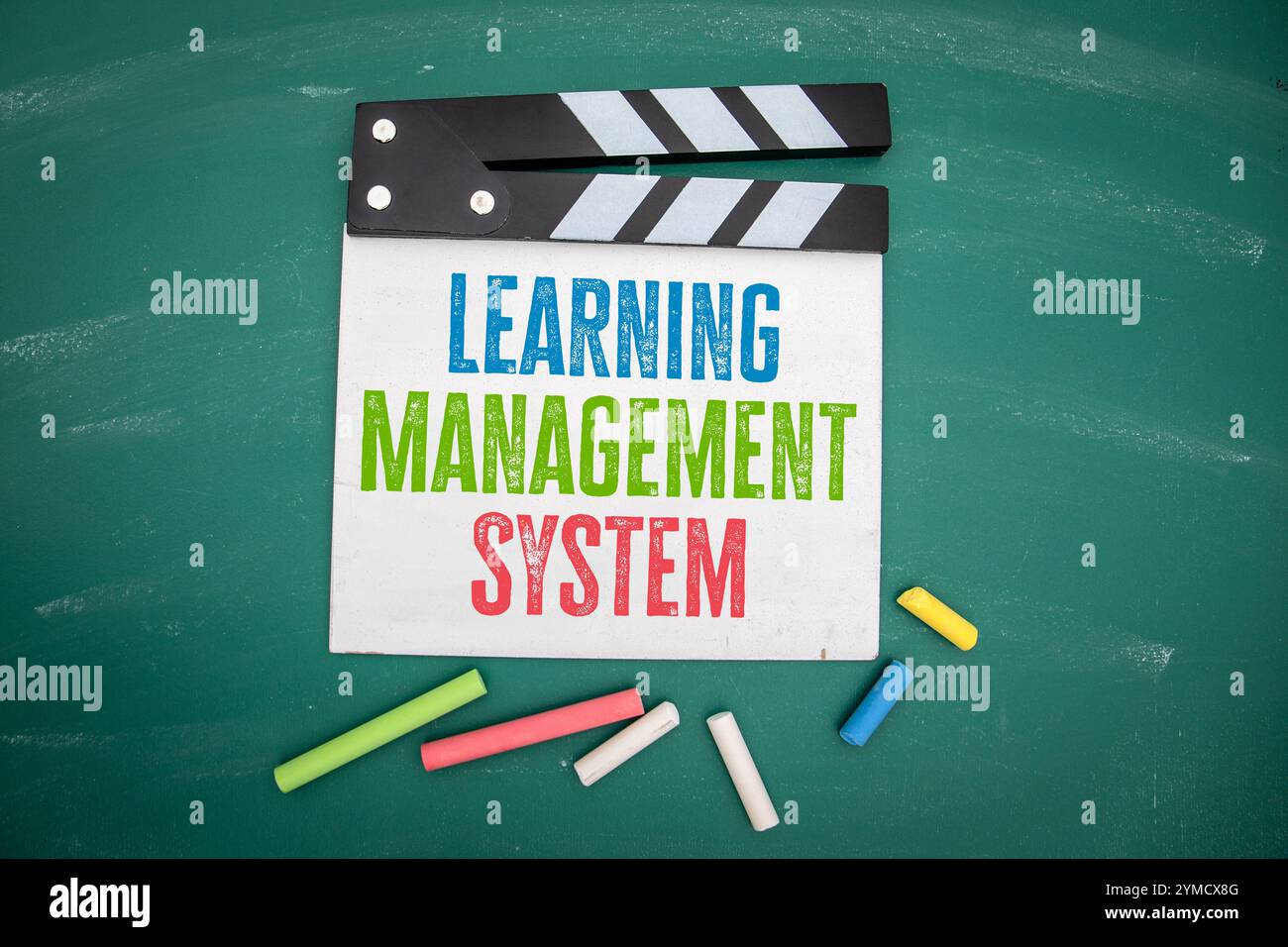 Learning Management System. Movie clapper and colored pieces of chalk ...