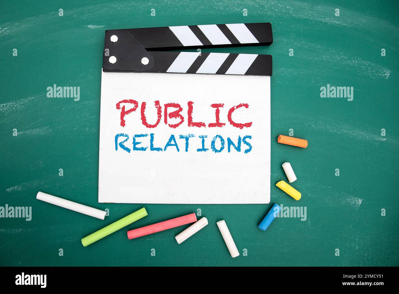 Public Relations. Movie clapper and colored pieces of chalk Stock Photo ...
