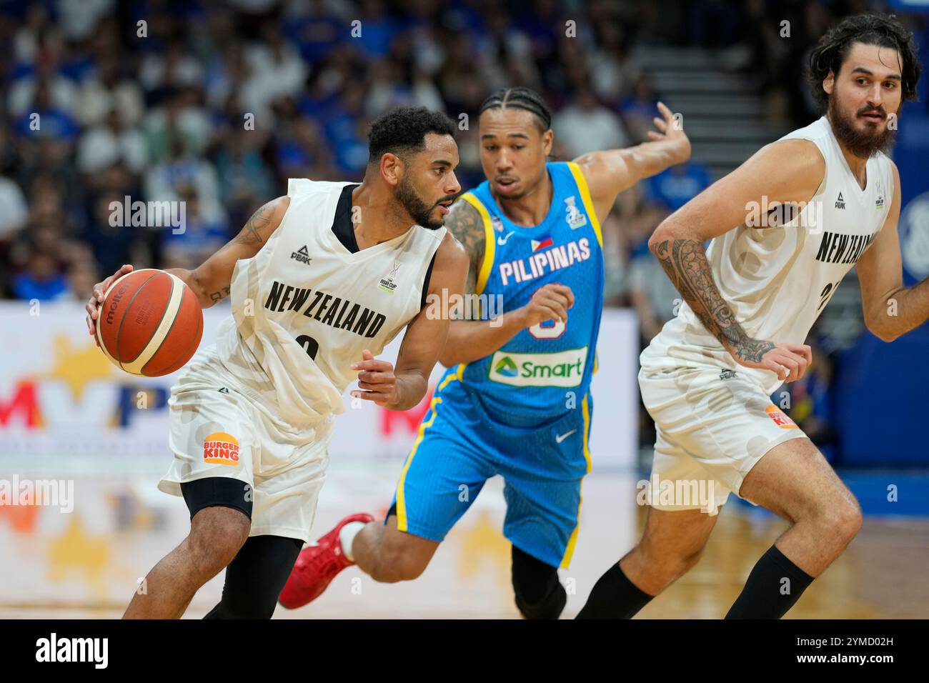 New Zealand's Corey Webster, left, dribbles the ball past Philippines ...