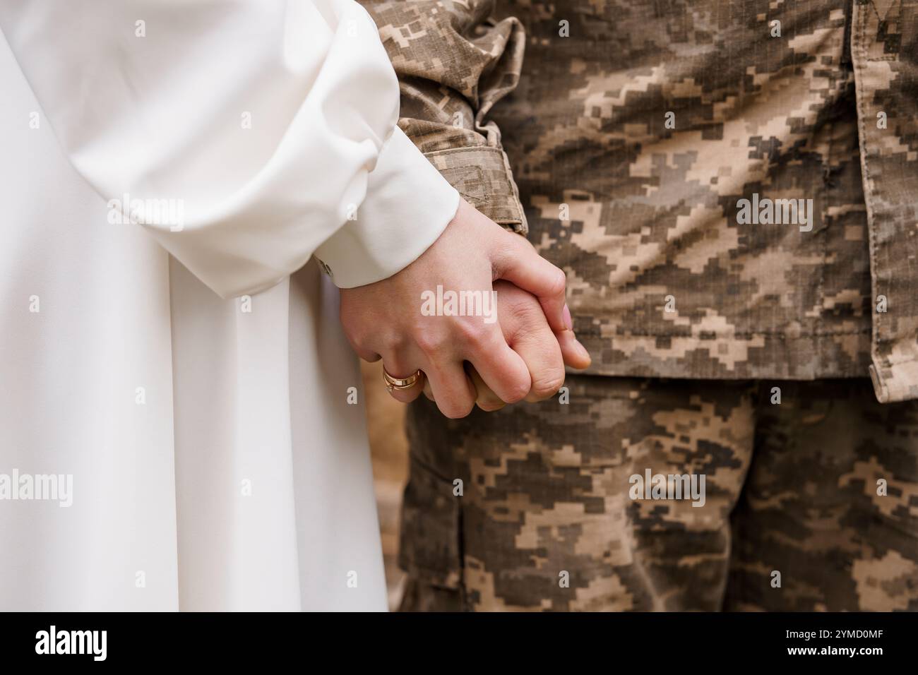 A Tender Moment: A Military Couple Holding Hands in Uniform and Wedding ...