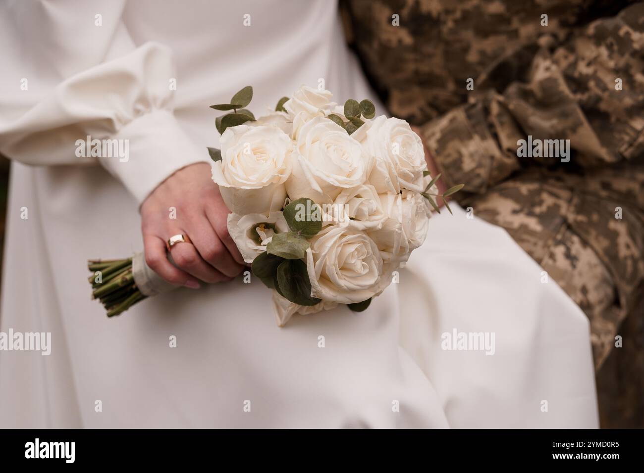 Elegant Bridal Bouquet in a Serene Military Setting Stock Photo - Alamy