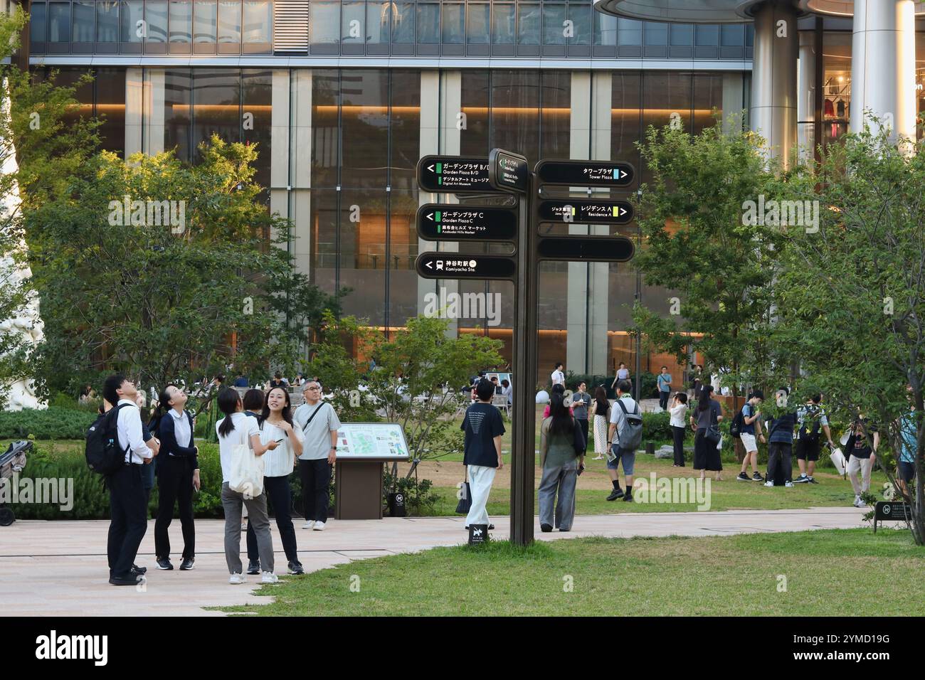 TOKYO, JAPAN - August 17, 2024: Visitors in the garden of the Azabudai ...