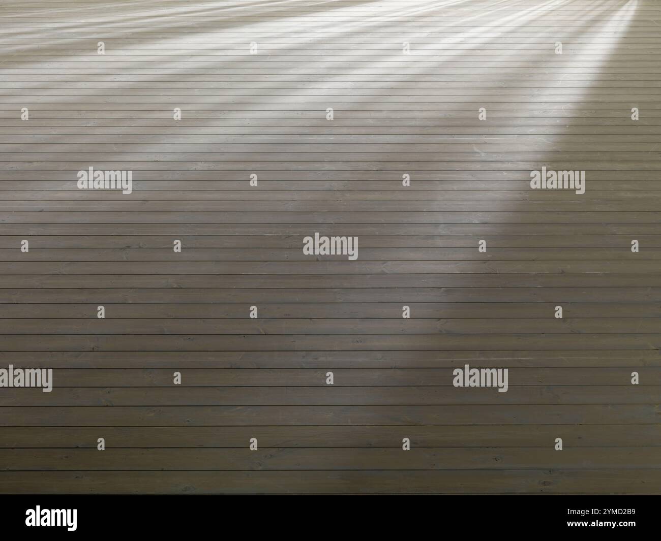 Wooden plank floor with beams of light created by the sun coming in ...