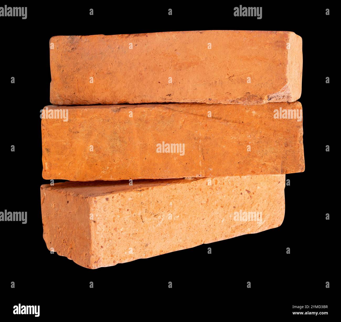 Side view of old red or orange bricks in stack is isolated on black ...