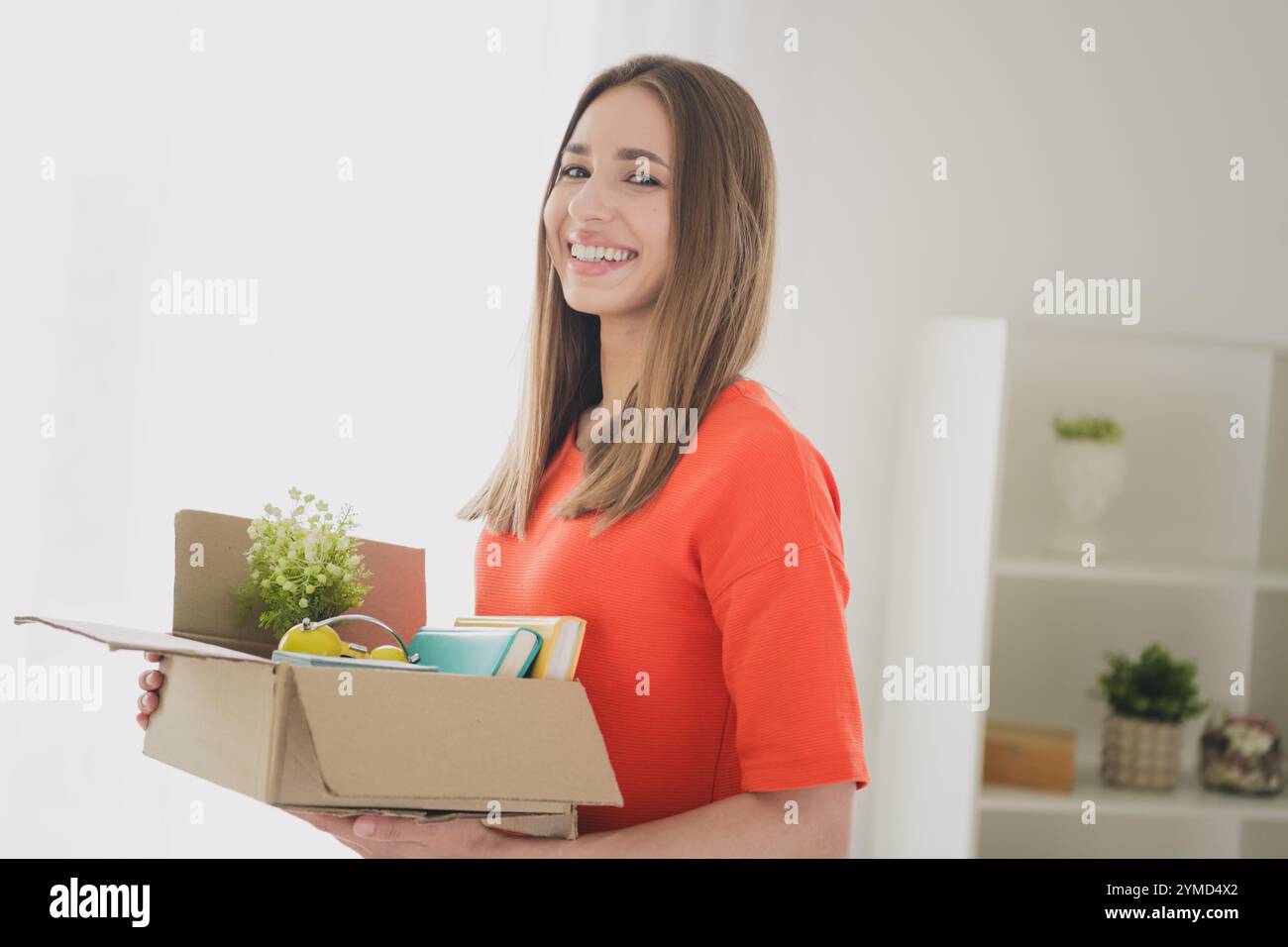Photo of lovely young girl carry carton box remove dressed orange ...
