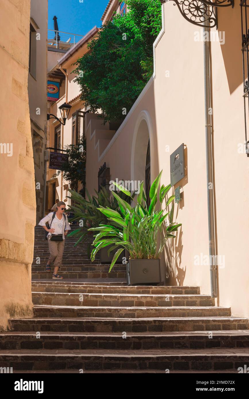 Old town Crete, view of a female tourist exploring a quiet street in ...