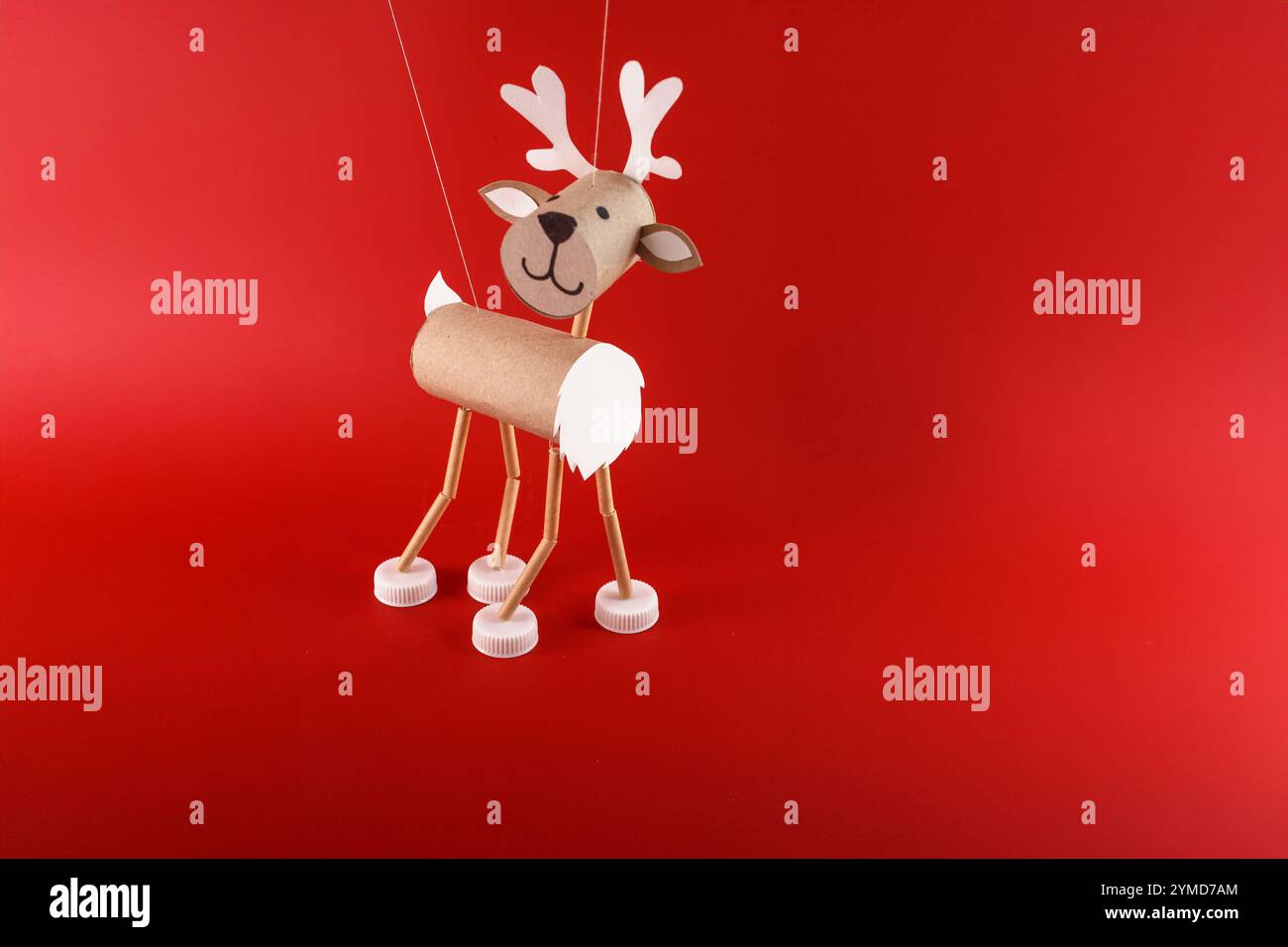 Handmade reindeer craft, cardboard tube body, straw stick legs, plastic ...