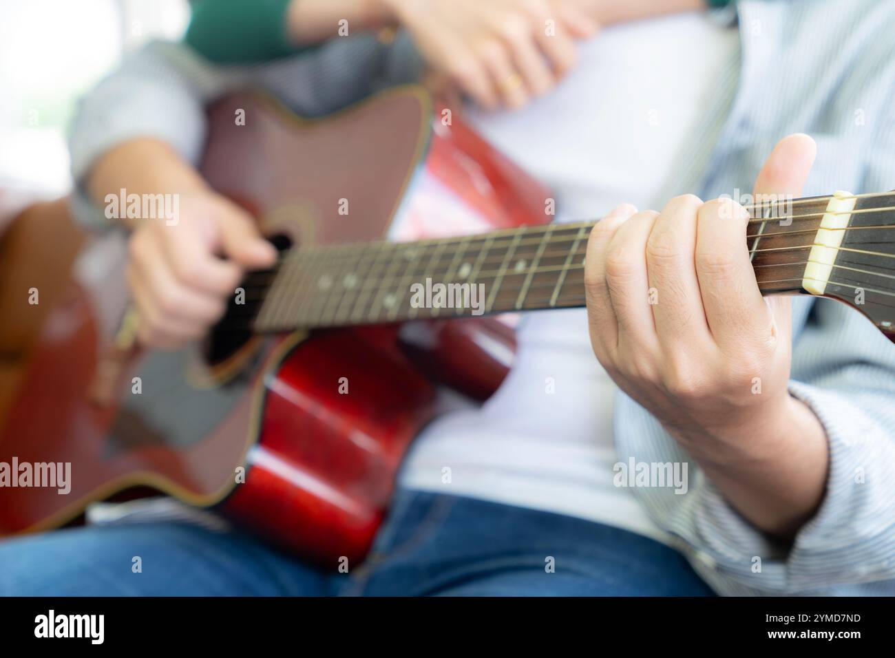 Girlfriend smiling playing guitar hi-res stock photography and images ...