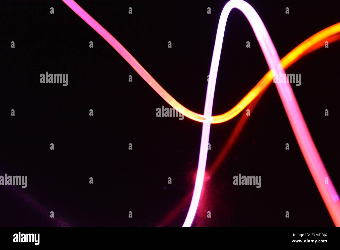 Multicolored light, beams of light pass along plastic twisted tubes ...