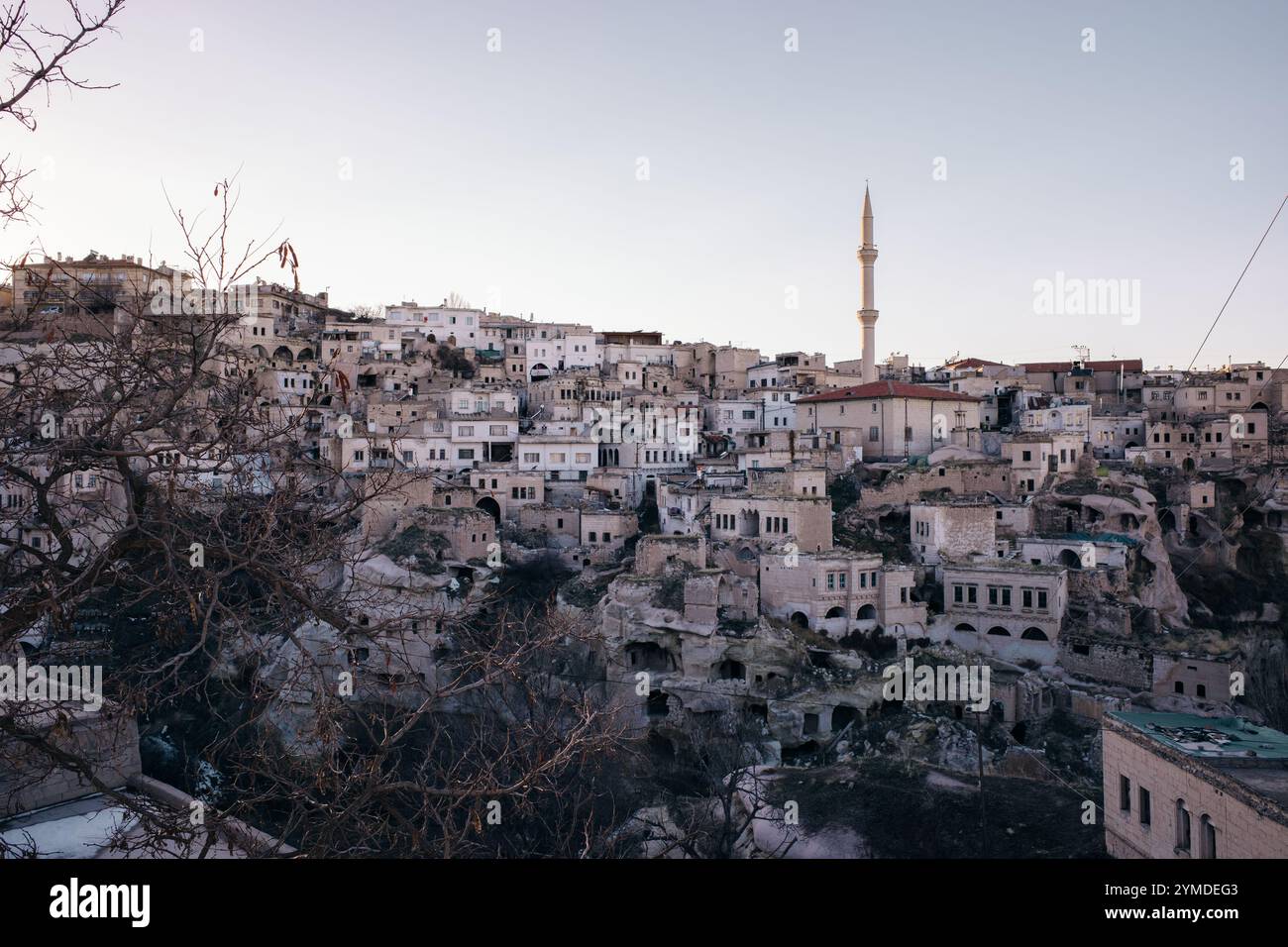 Ancient town and a castle of Uchisar dug from a mountains after sunrise ...