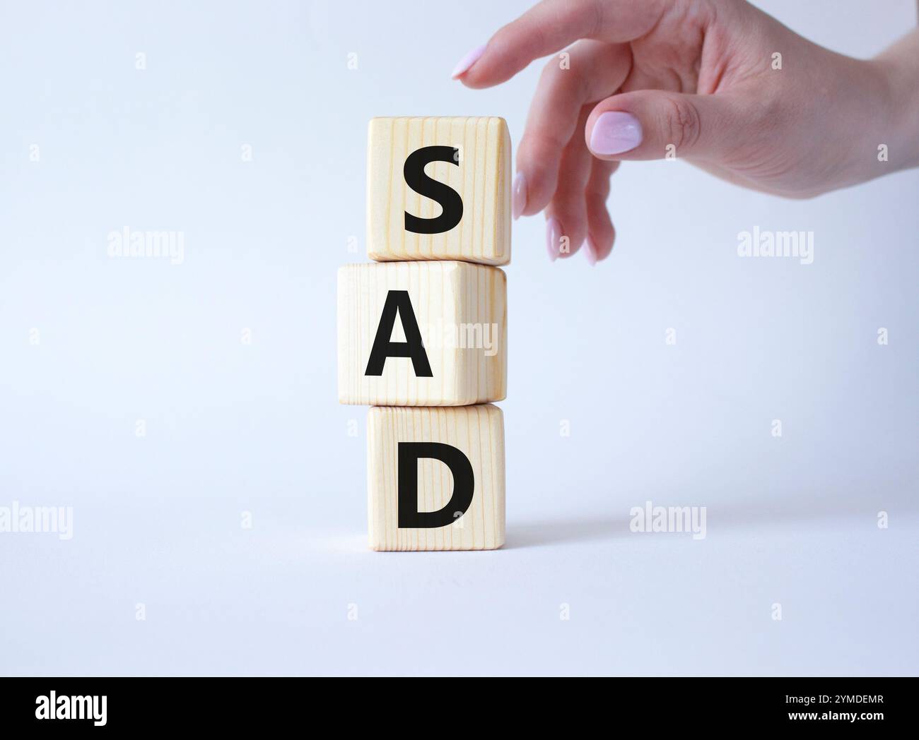 Sad symbol. Wooden cubes with words Sad. Businessman hand. Beautiful ...
