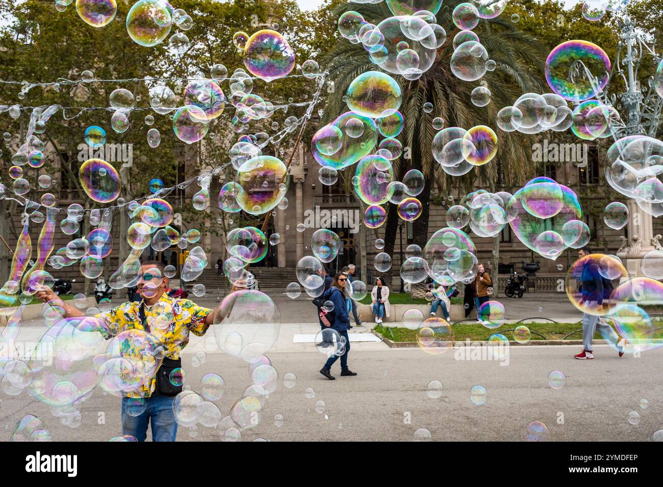 Tourists, children and locals alike walk by and engage with the street ...