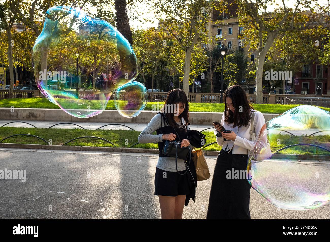 Tourists, children and locals alike walk by and engage with the street ...