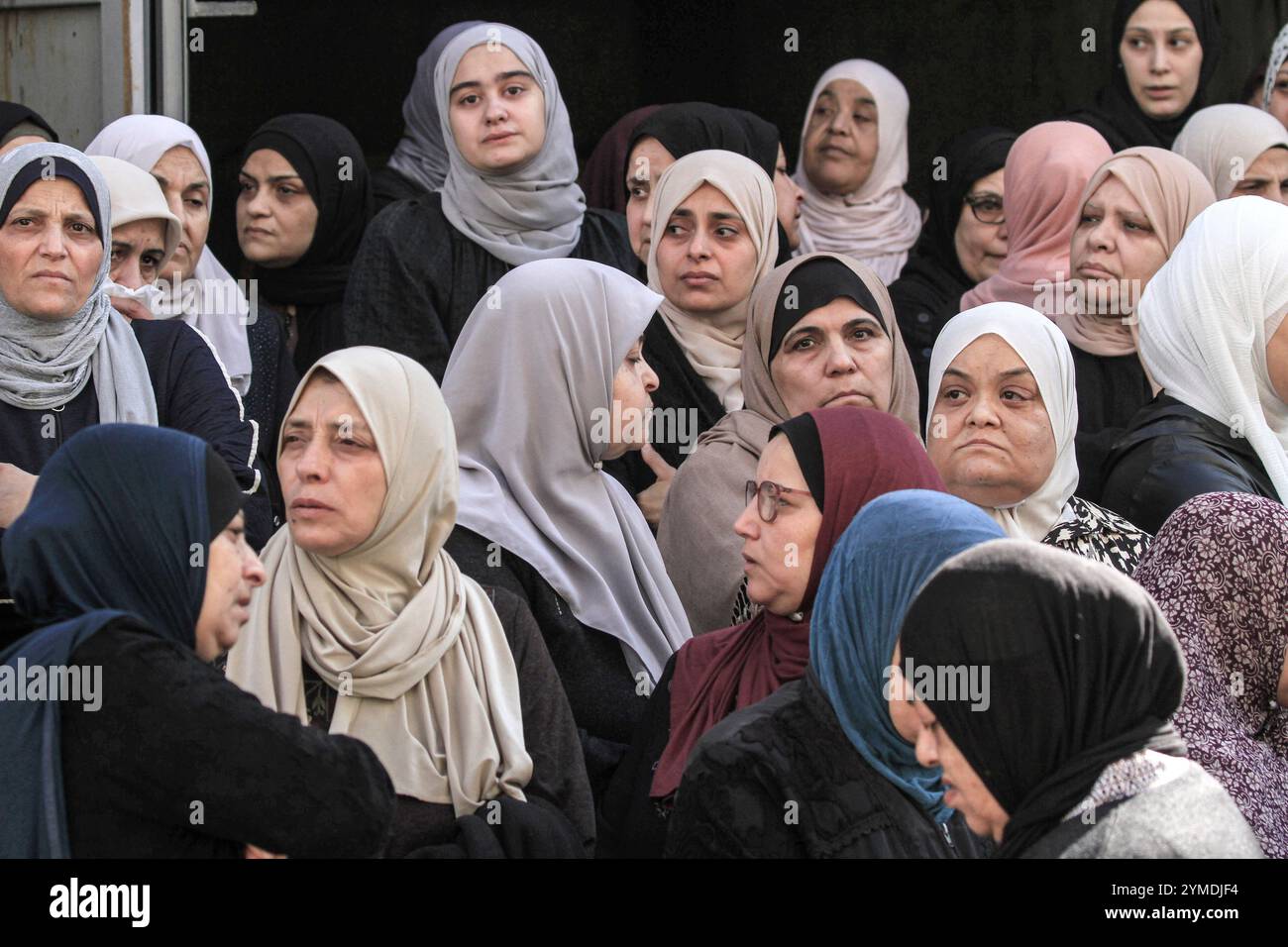 Palestinian women wait for the body of martyr Jihad Qatouni in Ein Beit al-Maa camp, who was ...