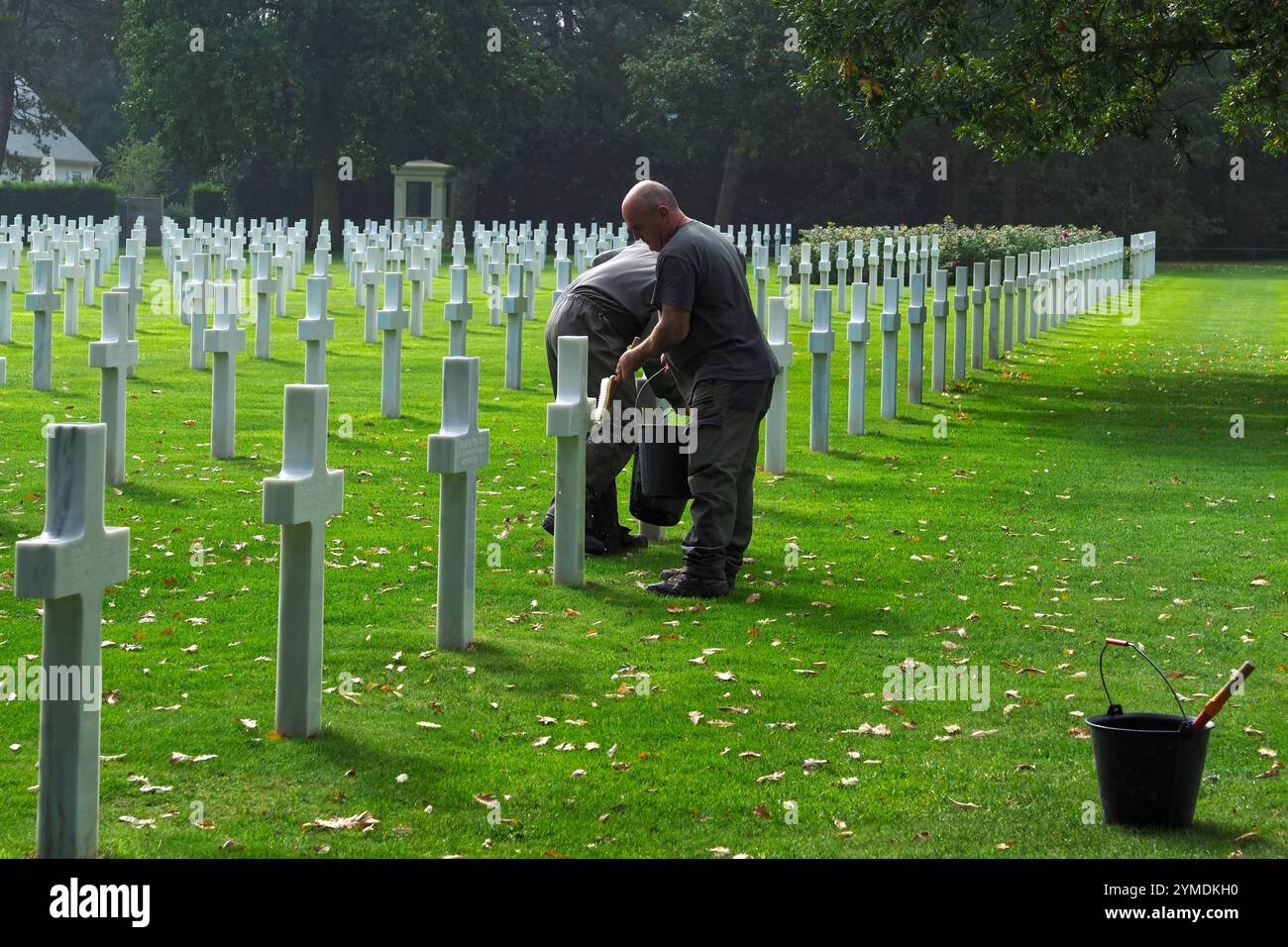 workmen clean the grave markers of fallen US service personnel ...