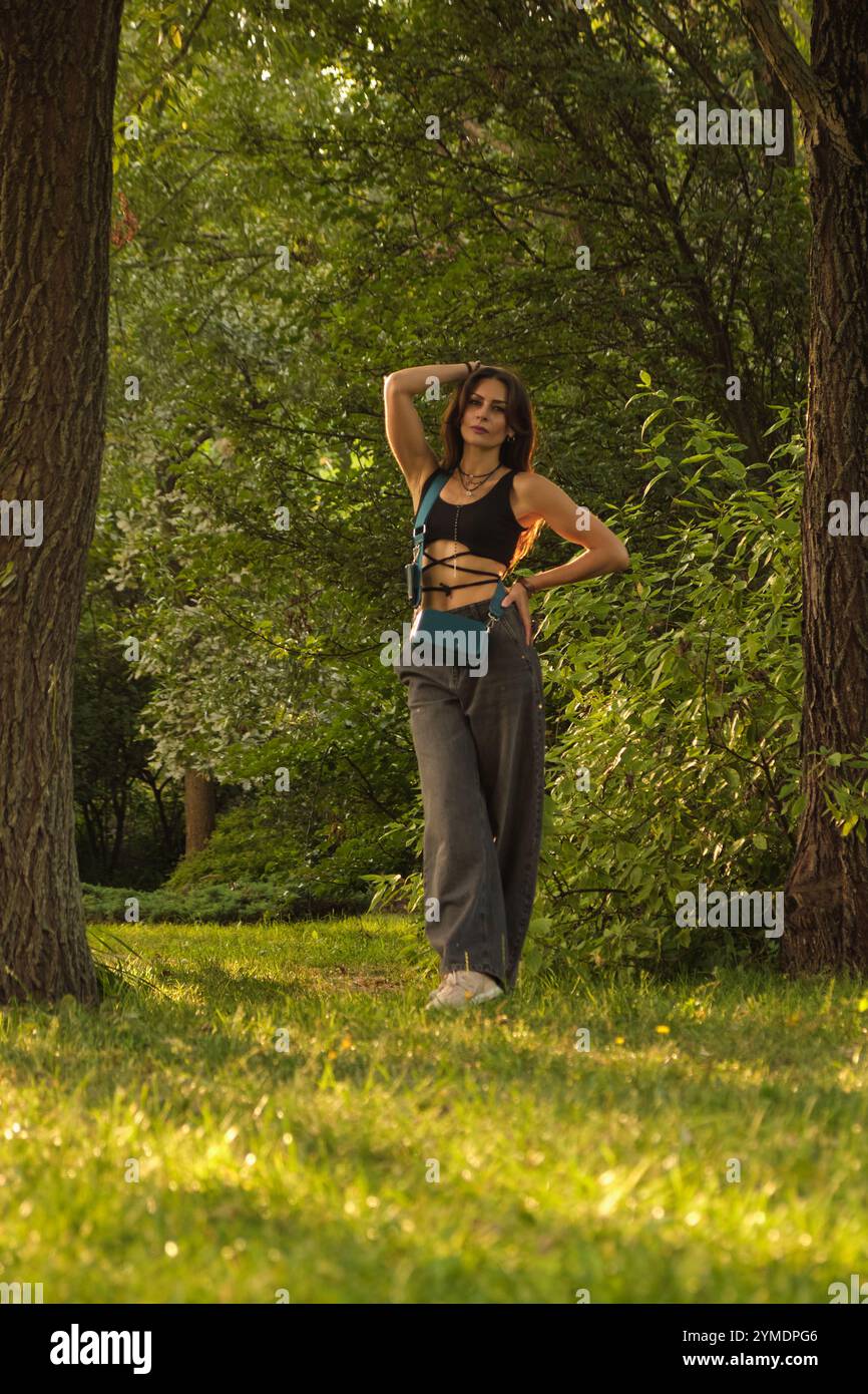 Woman standing tall with arms lifted, embracing the natural beauty of a ...