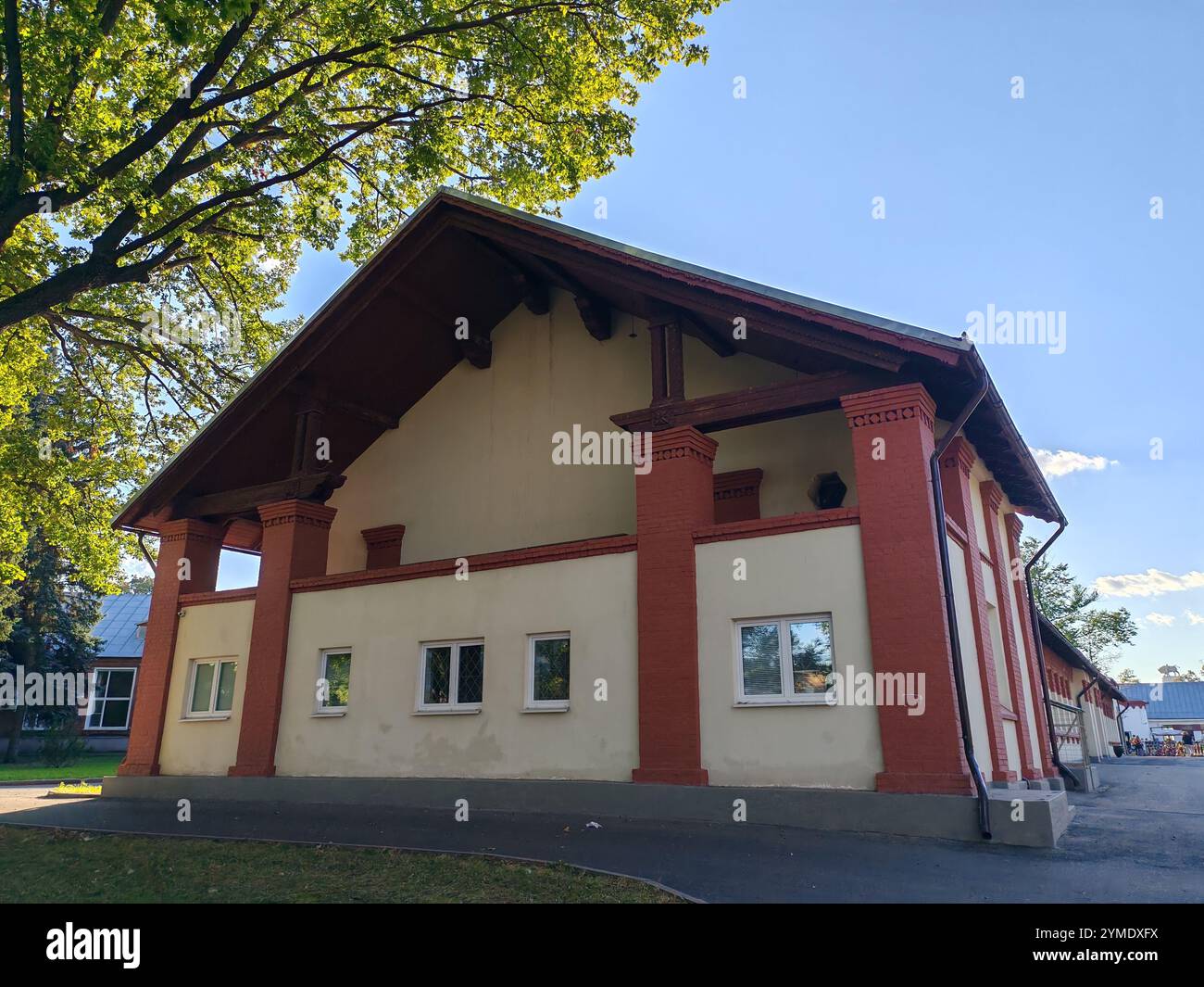 historic building with red brick columns and a sloping roof, nestled ...