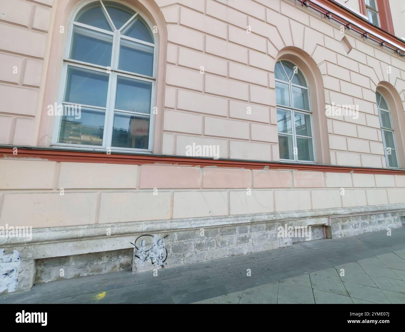 grand yellow building with symmetrical windows and classical detailing ...