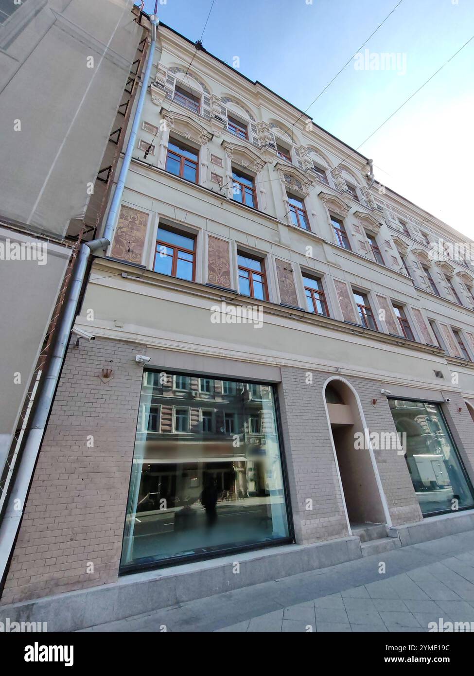 grand yellow building with symmetrical windows and classical detailing ...