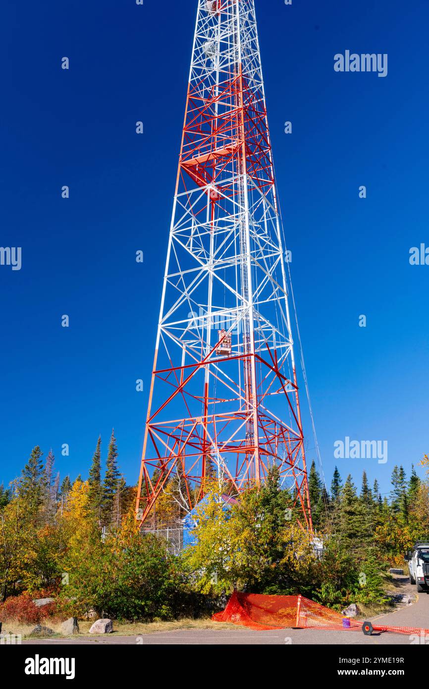 A worker paints a communications tower at Palisade Head, a Lake ...