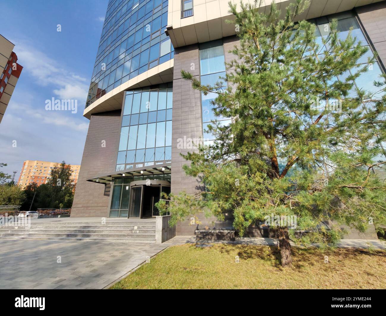 Modern Urban Building With Large Glass Sections And Angular Panels Featuring Minimalist Design