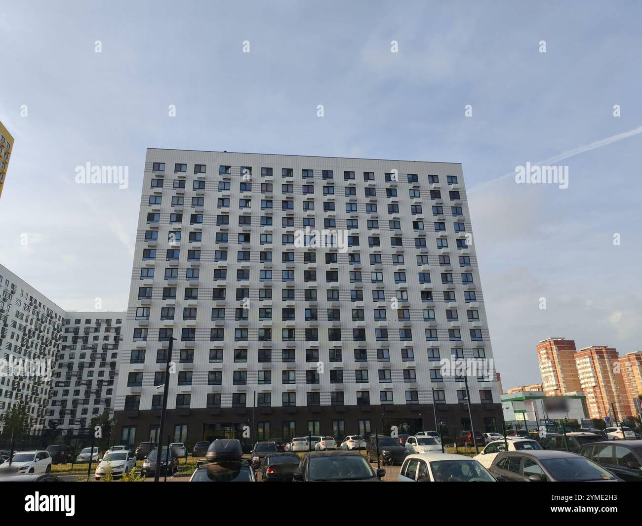 Two high-rise buildings featuring a dynamic contrast of yellow and ...