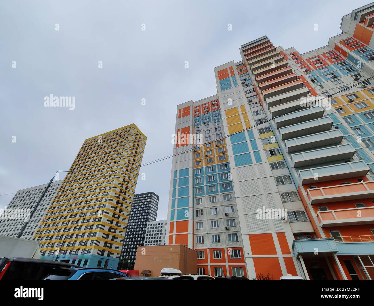 A towering residential building with pastel accents, featuring a wide ...