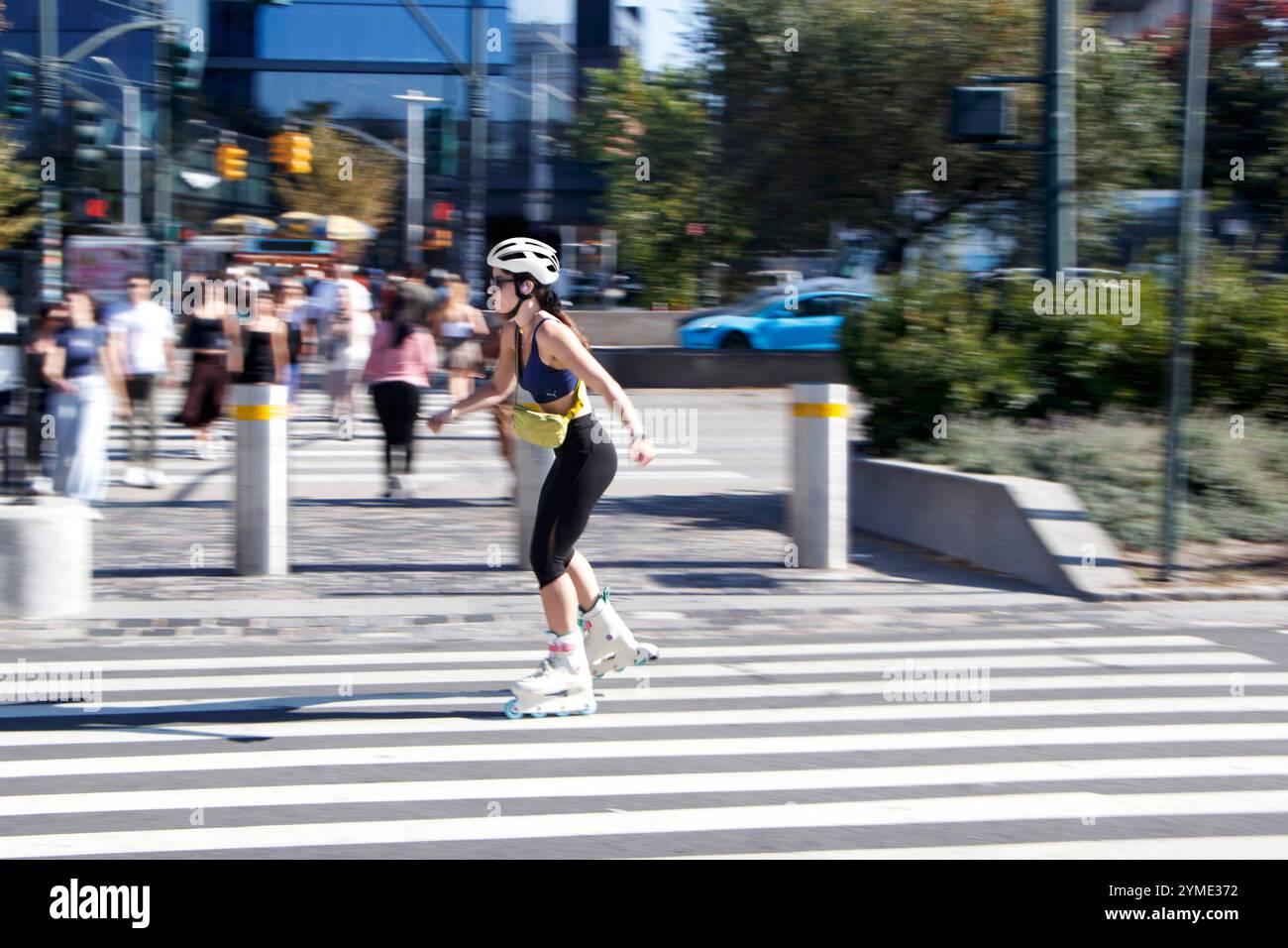 panning shot at speed of a woman roller skating near pier 57 manhattan ...