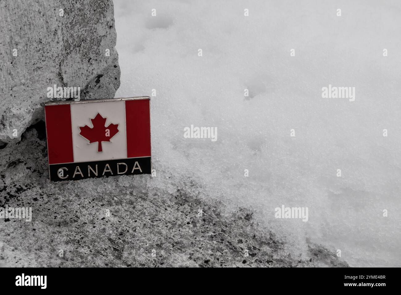 Canadian flag ornament on a stone with snowy background Stock Photo - Alamy