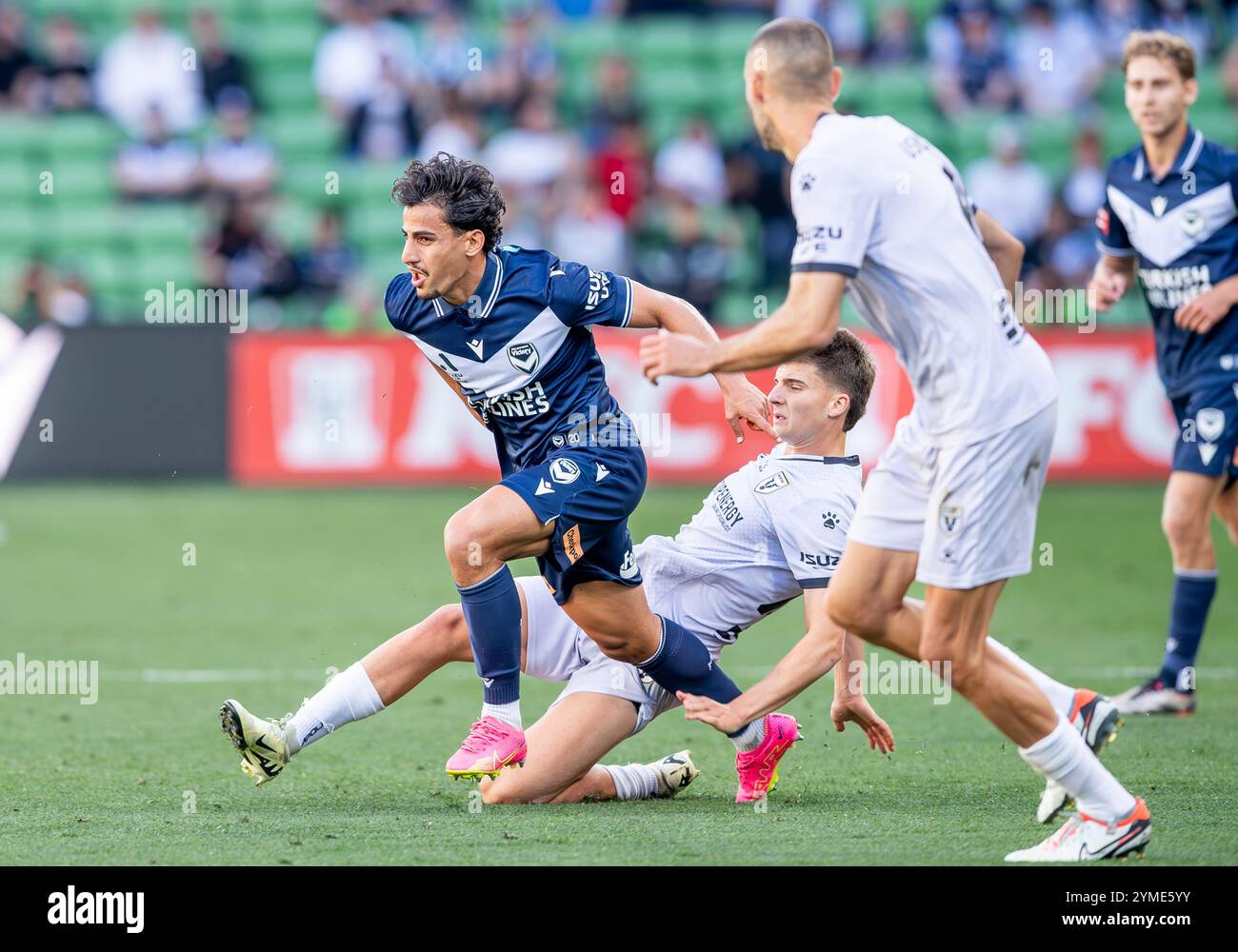 Melbourne Victory's Daniel Arzani escapes a tackle by Maccarthur ...