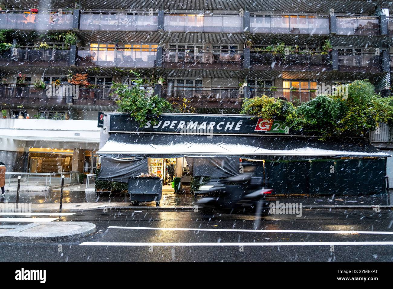 This photograph shows storefronts covered in snow on a snowy day. Paris ...