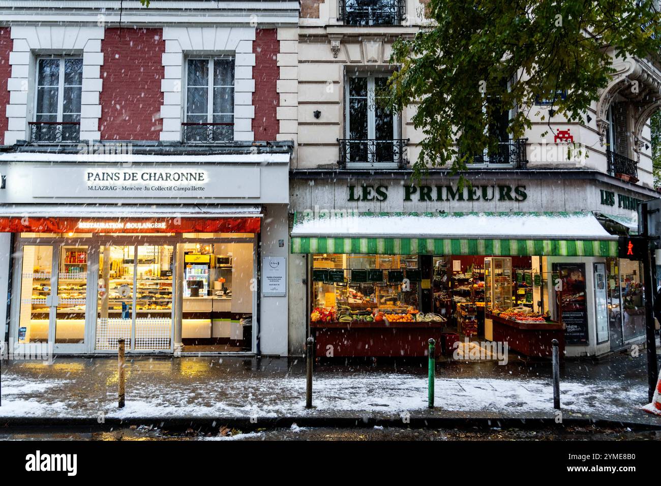 This photograph shows storefronts covered in snow on a snowy day. Paris ...