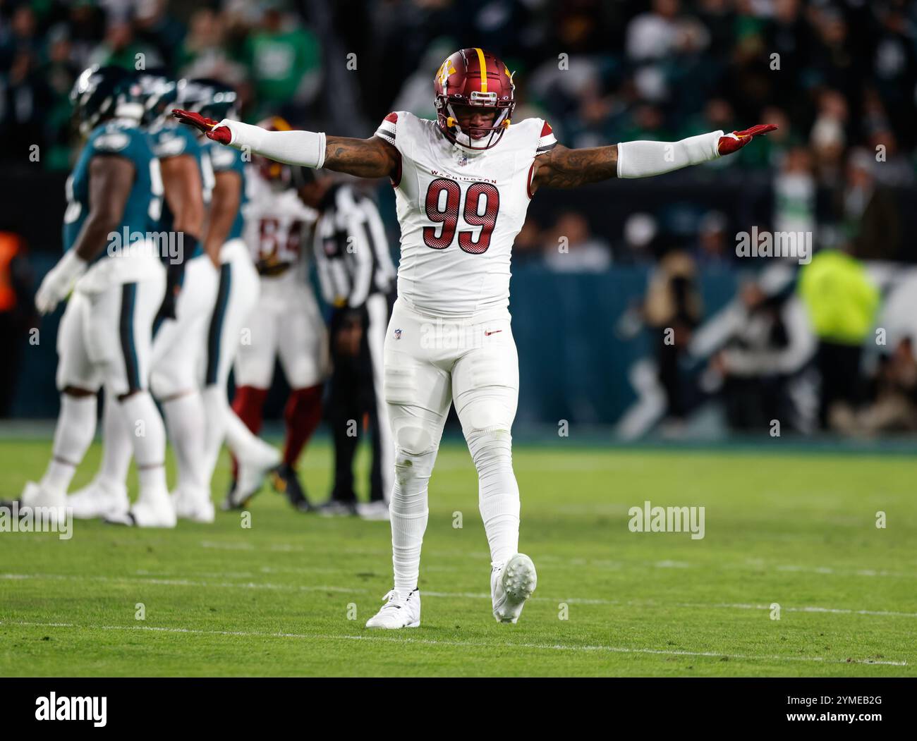 Washington Commanders defensive end Clelin Ferrell (99) signals for a ...
