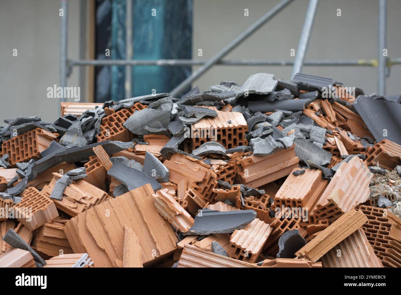 Close-up of mixed construction waste with new building in the ...