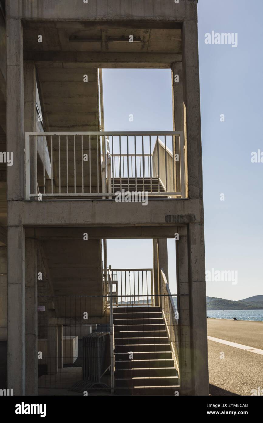 Silhouetted exterior concrete stairwell on dock at newly built modern ...