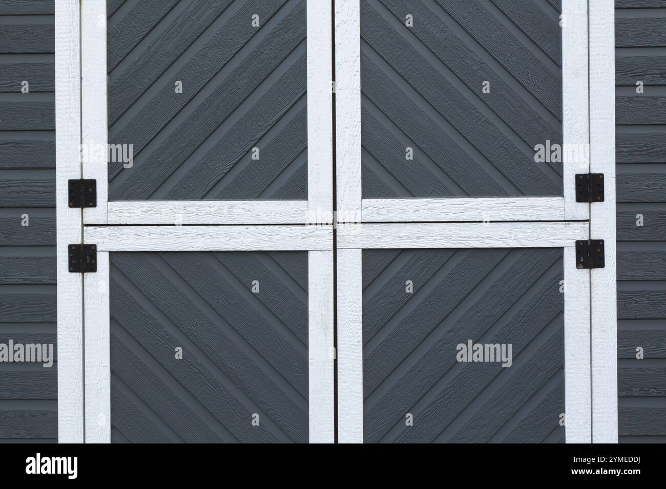 Individual small square doors on storage shed cladded with grey and ...