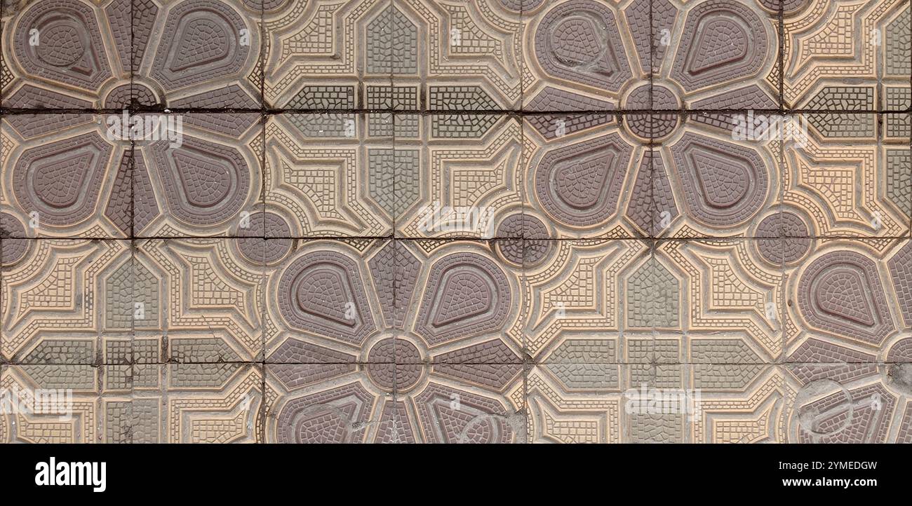 Colorful sidewalk tiles with geometric shapes in an urban environment ...