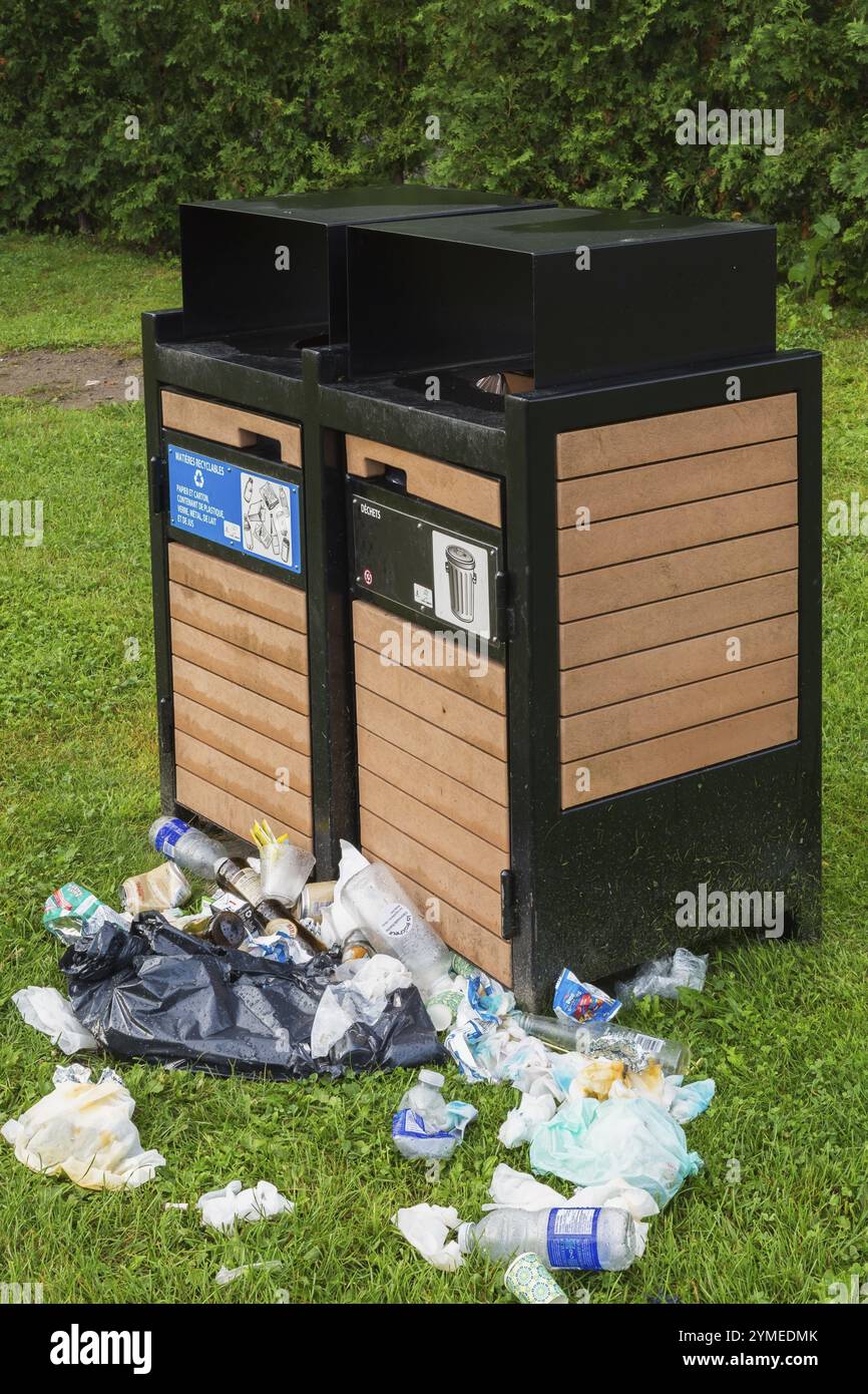 Black painted metal and natural wood garbage recycling bins with ...