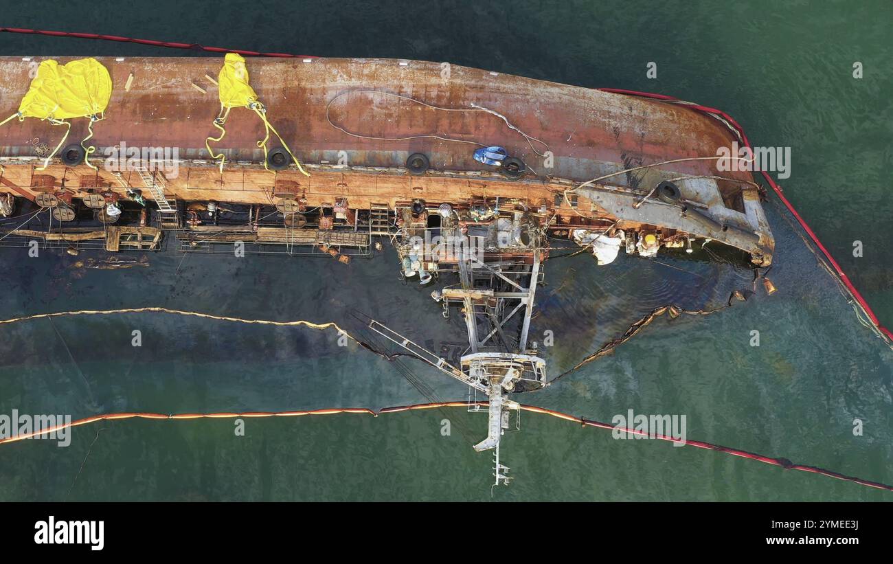 Aerial top view from drone of overturned broken rusty oil tanker ship ...