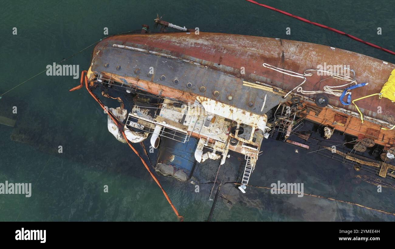 Aerial top view of overturned broken rusty oil tanker ship after the ...