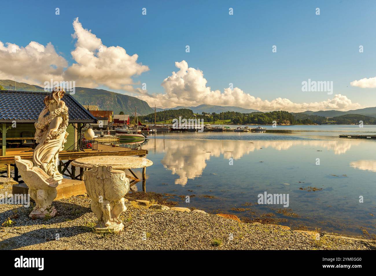 Stone figure, harbour, fishing village Norway, Valsoyfjorden, public ...