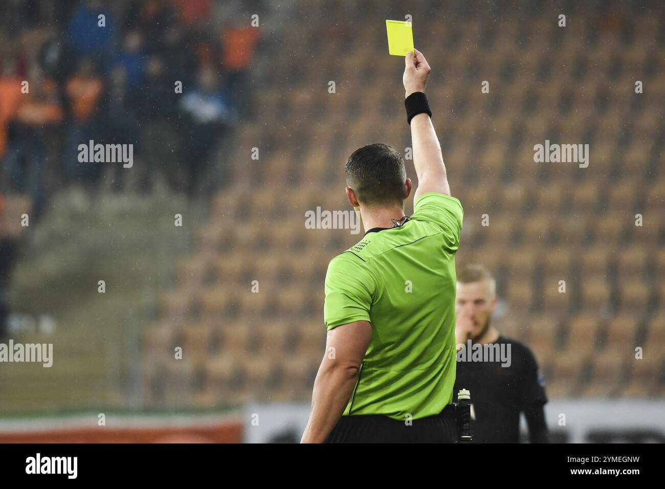 Referee shows footballer yellow card during soccer match at the stadium ...