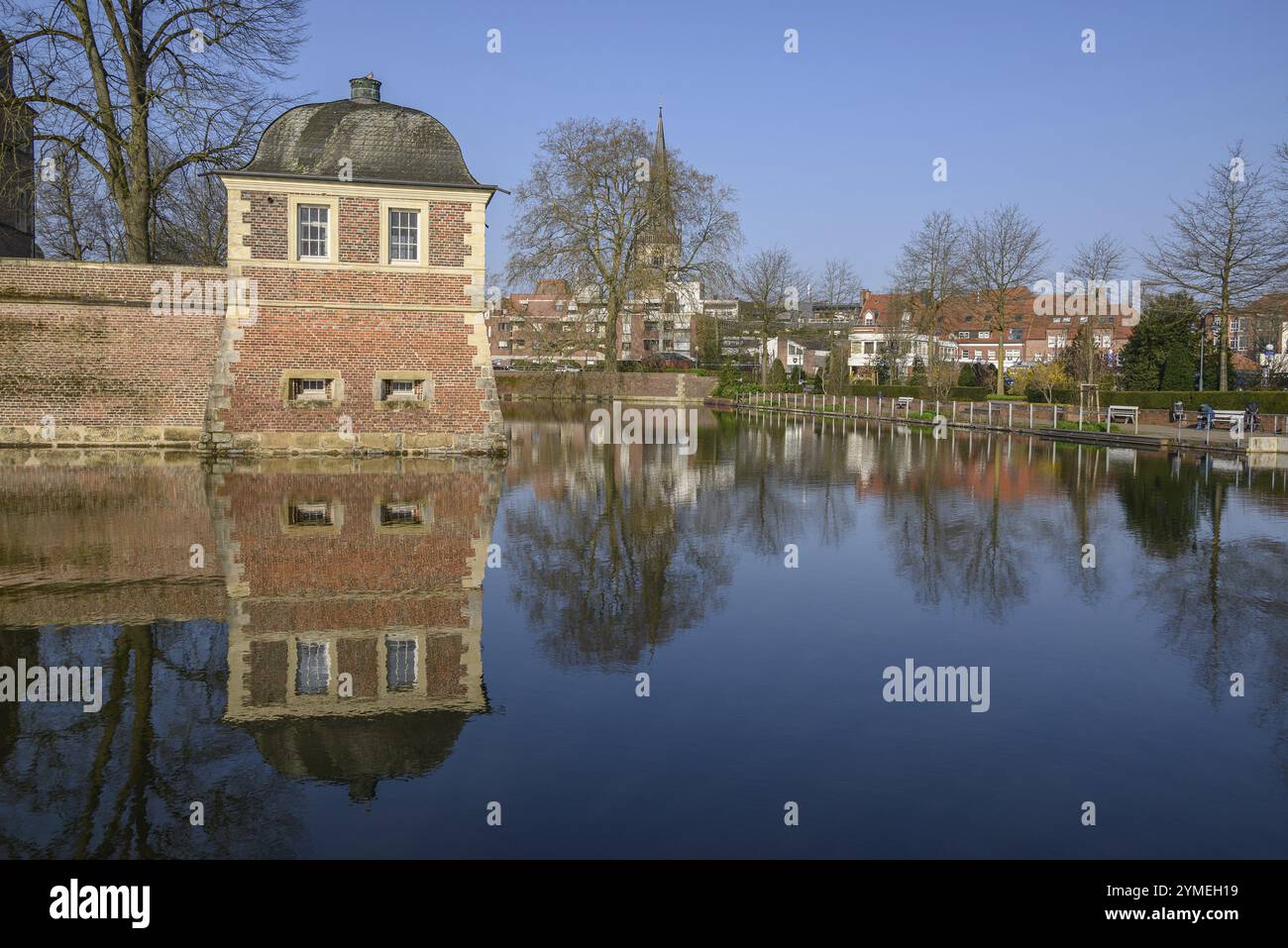 A pavilion at the moat with a clear reflection, surrounded by trees in ...