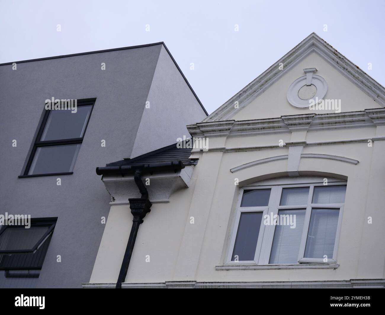 Contrasting architectural styles as a modern development abuts a ...