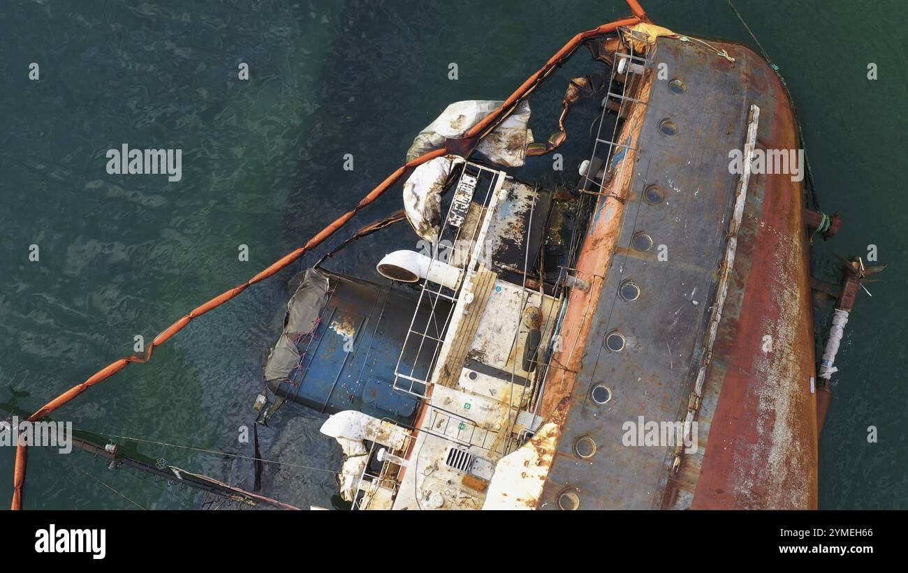 Close up top view of broken old rusty overturned oil tanker ship after ...