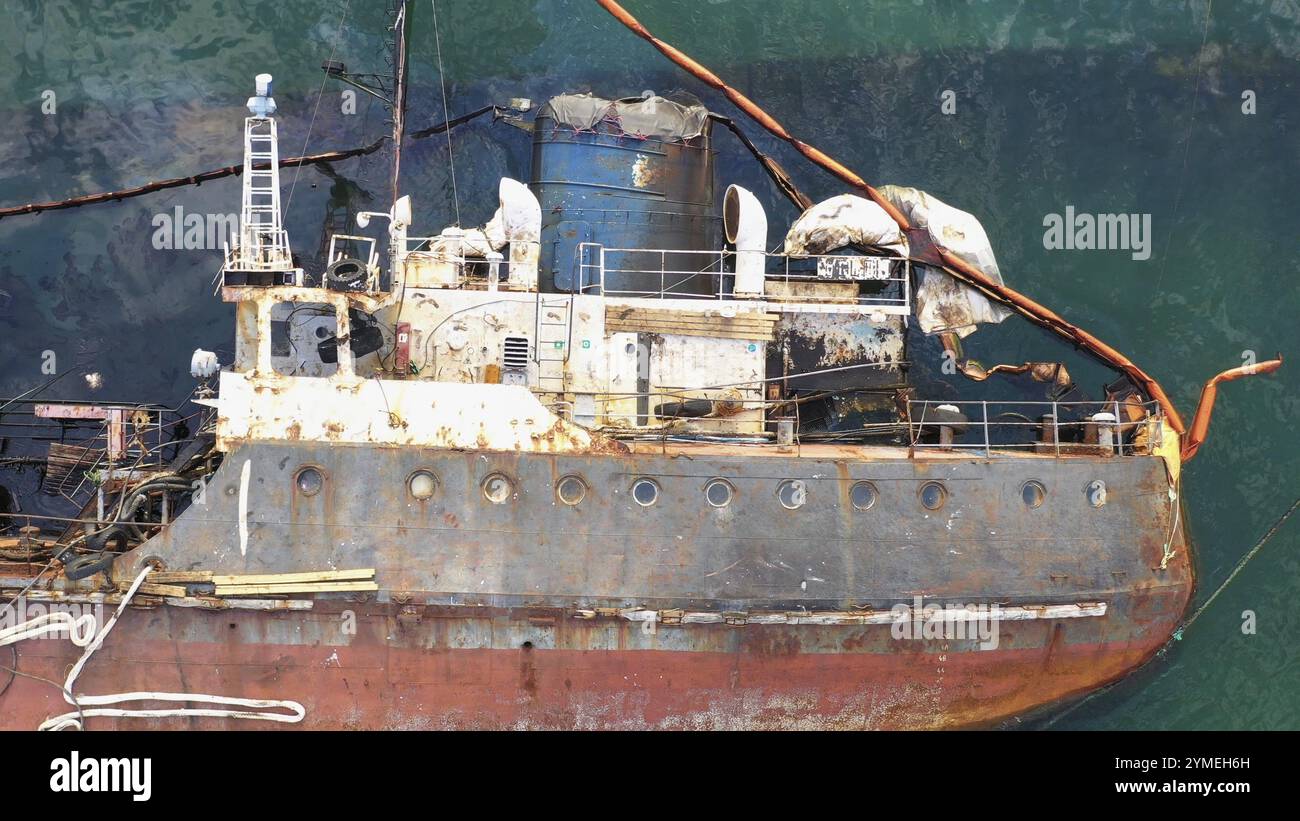 Aerial top view of overturned broken rusty oil tanker ship after the ...