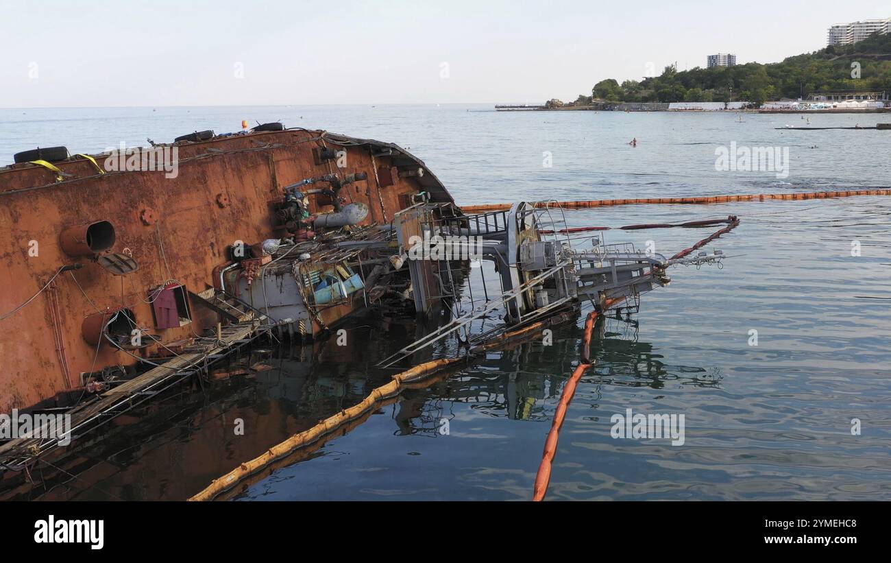 Overturned rusty oil tanker ship in the shallow water. Drowned sunken ...